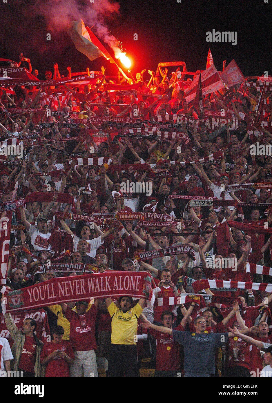 Liverpool supporters let off flares and greet their side before the ...