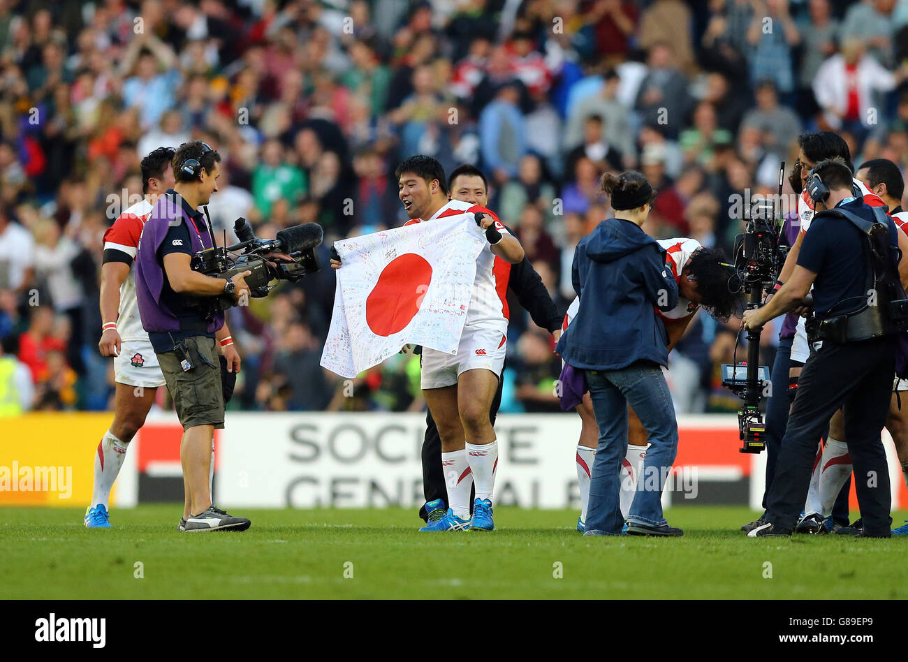 Japan players celebrate victory after the Rugby World Cup match at the ...