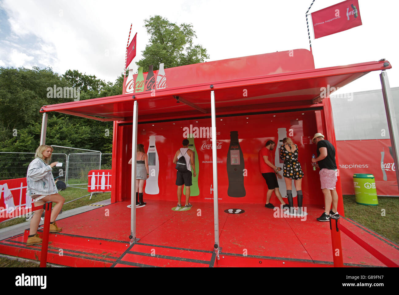 Festival goers receiving drinks in the Coca-Cola Share a Coke party pod ...