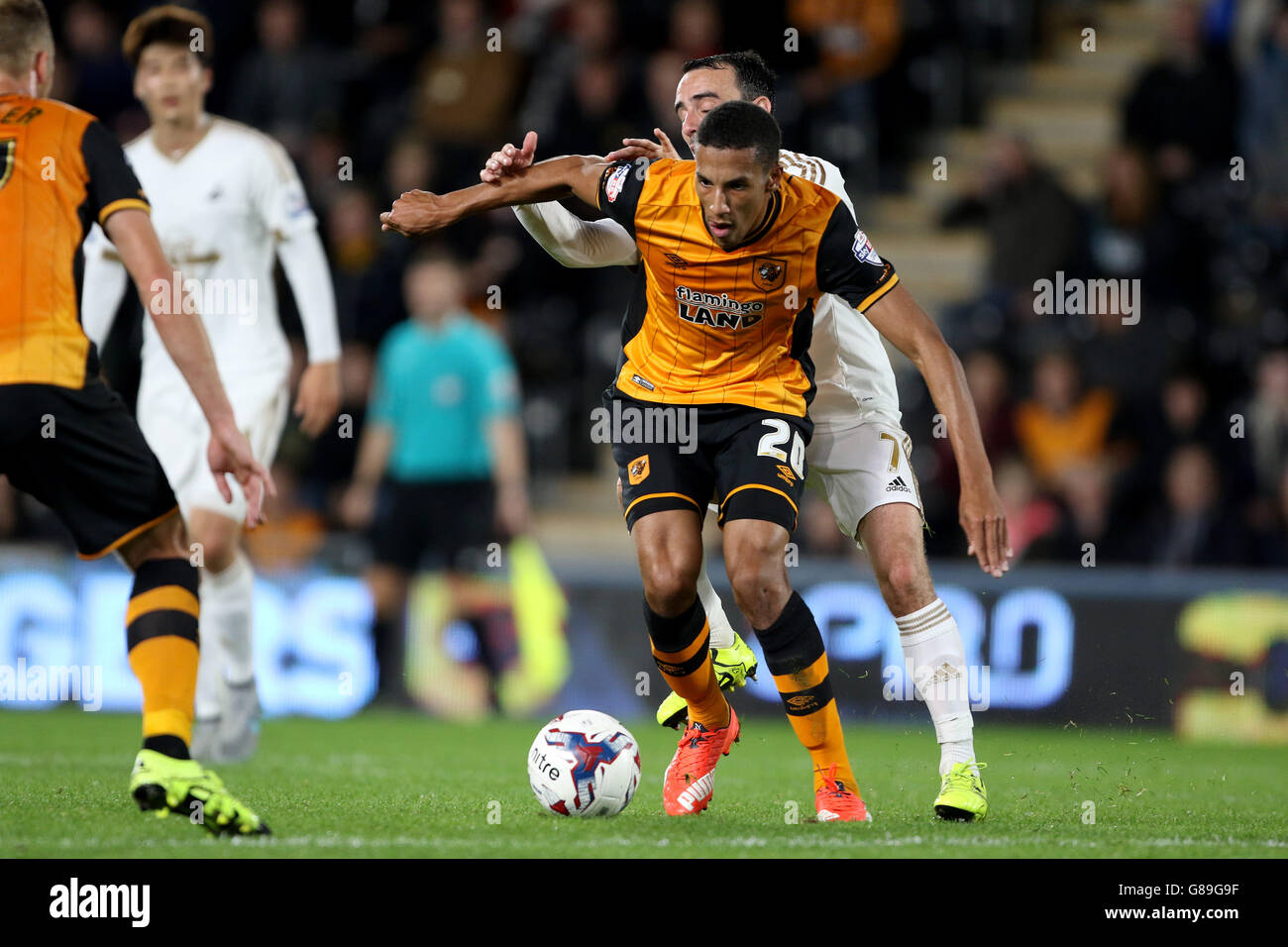 Hull City's Isaac Hayden holds off Swansea City's Leon Britton during ...