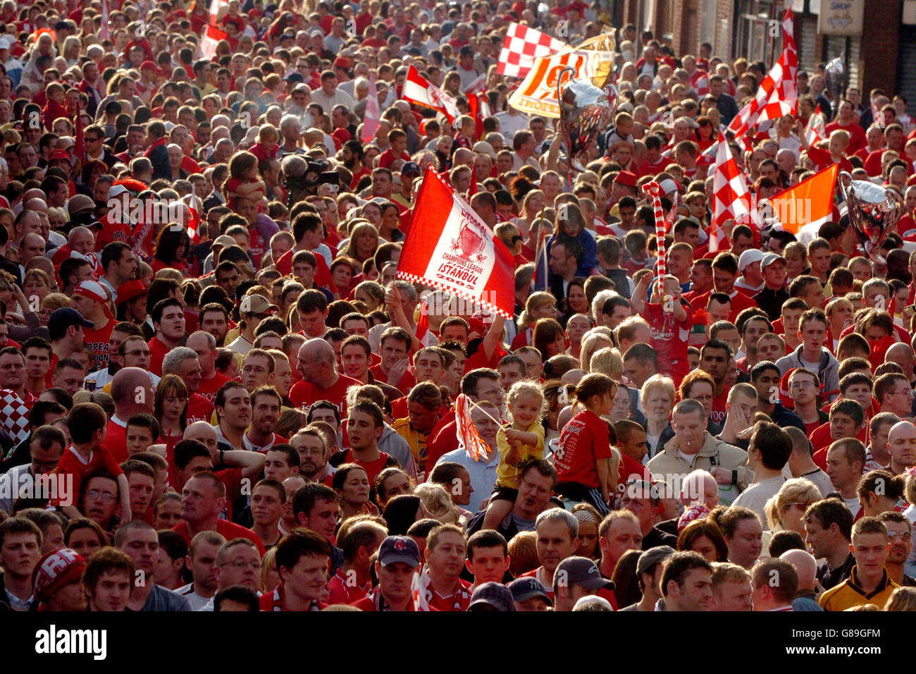 Liverpool fans celebrate in the street as they await the arrival of the ...