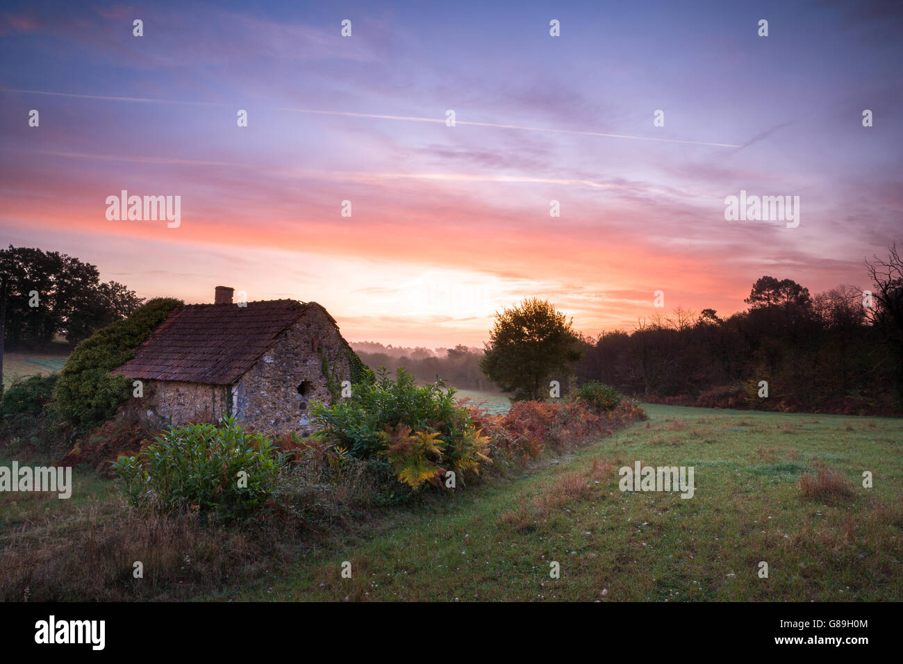 Abandoned cottage at sunrise with a colourful sky and mist Stock Photo ...