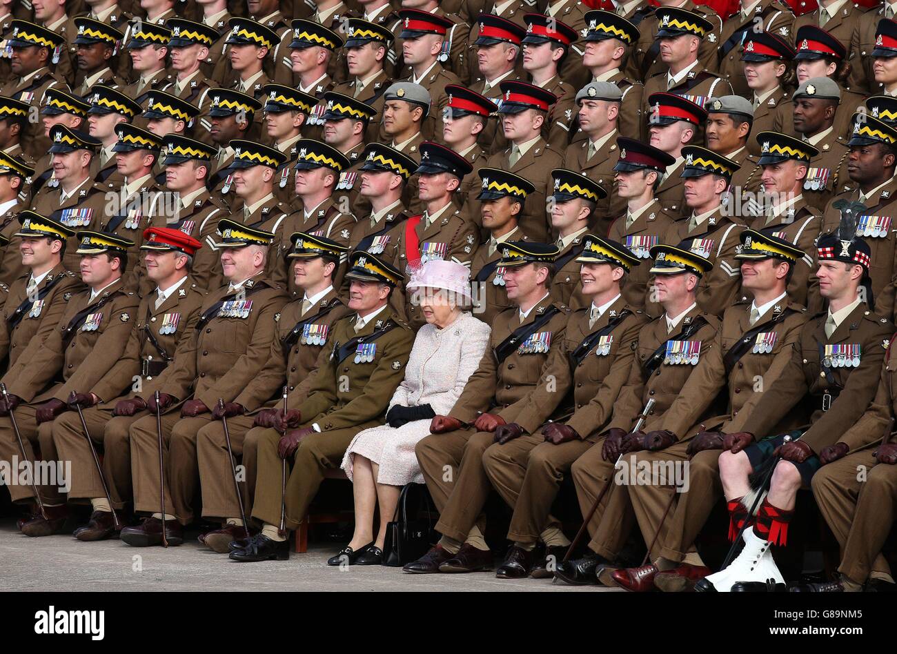 Queen Elizabeth II joins soldiers for a regimental photograph during a ...