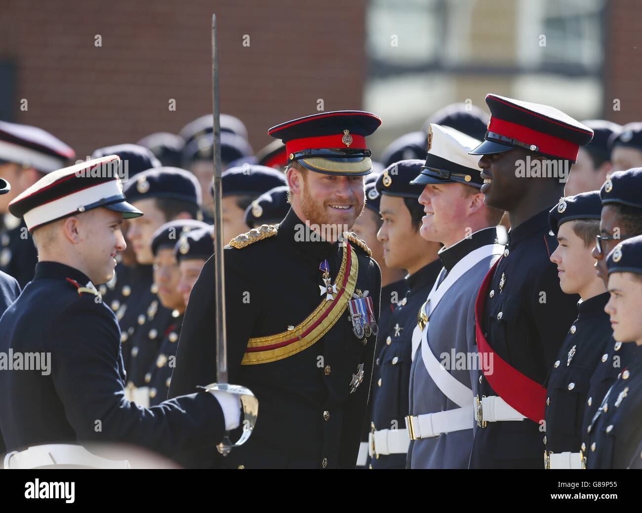 Prince Harry inspects the student guards during his visit to the Duke ...