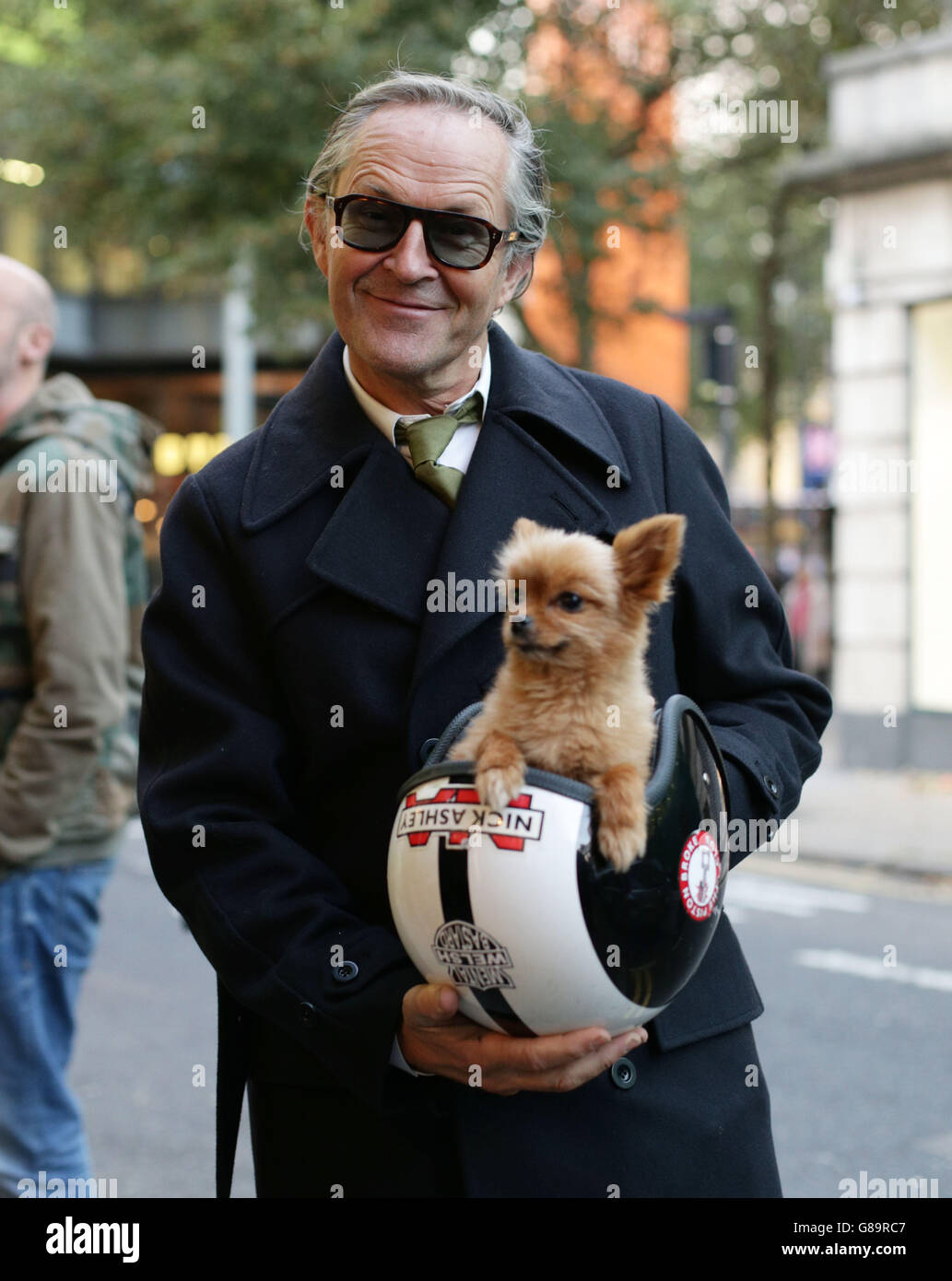 Nick Ashley, son of Laura Ashley, with Pomeranian dog Cookie attending ...