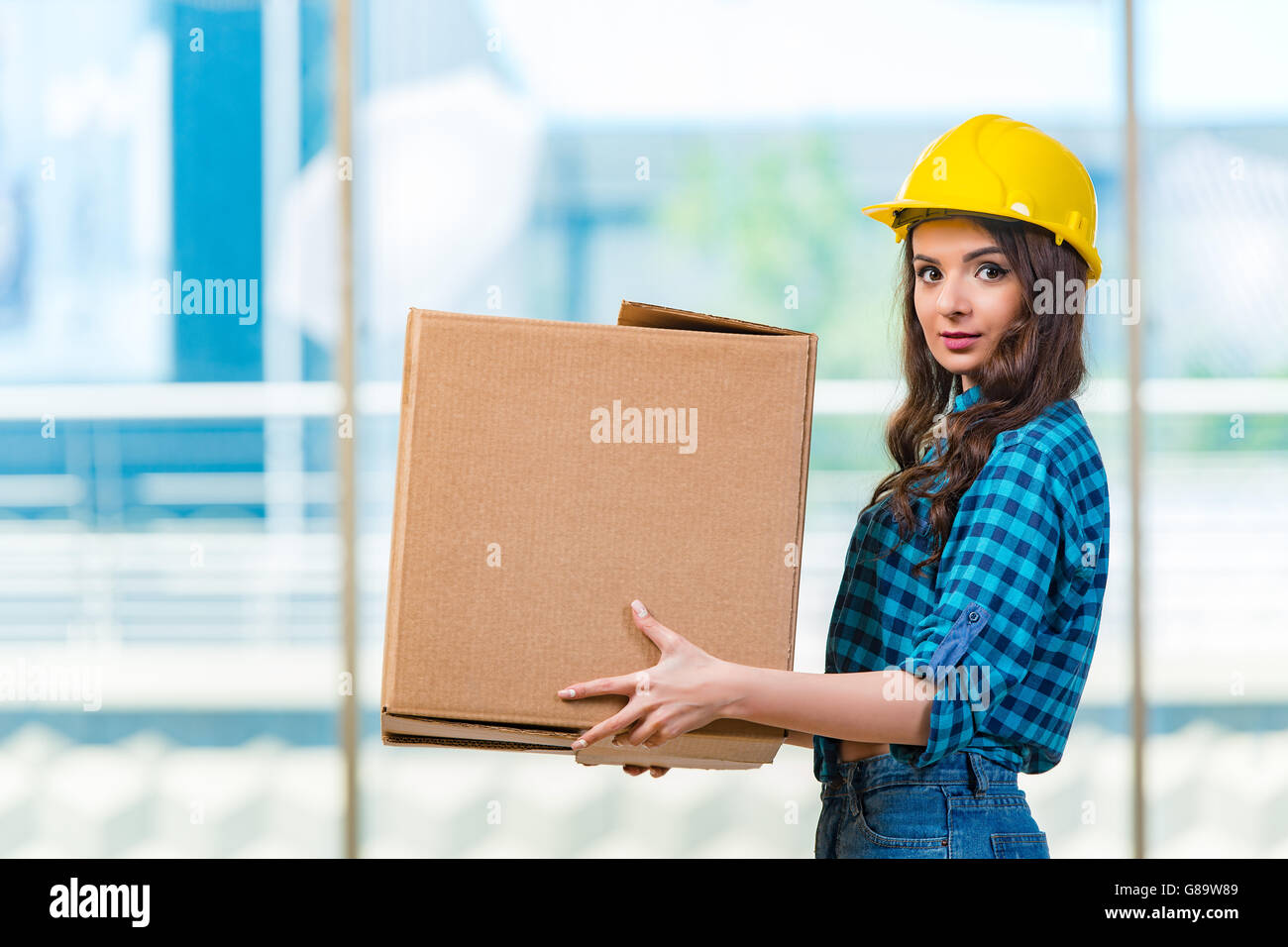 Nice young woman carrying box Stock Photo - Alamy