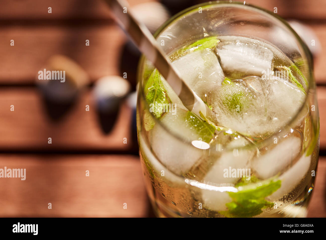 Having a nice cool drink in a glass with mint and ice on a wooden table ...