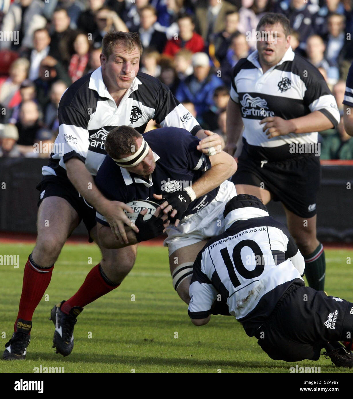 Scotland's Stuart Grimes is tackled by Barbarian's Gary Longwell (L ...
