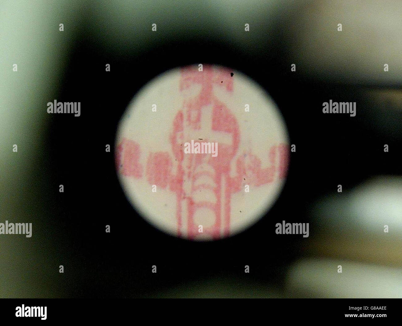 A watermark in a British Passport is examined under a microscope Stock ...