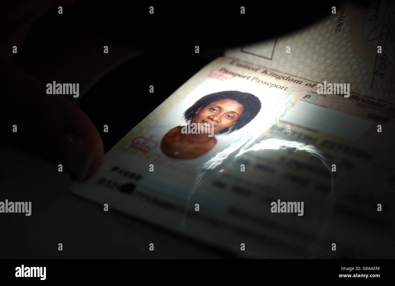 A forged British passport is scanned by a video spectral comparator ...