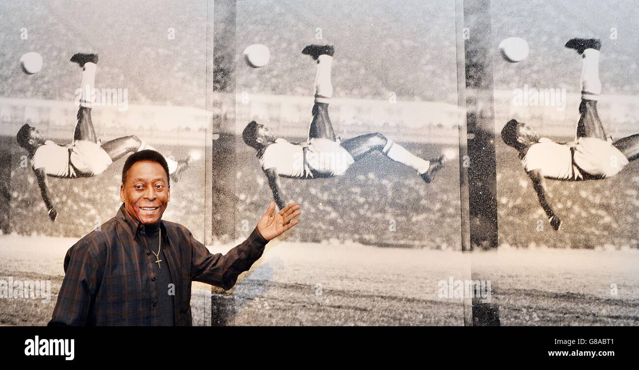 Legendary Brazilian footballer Pele, stands in front of a triple image ...