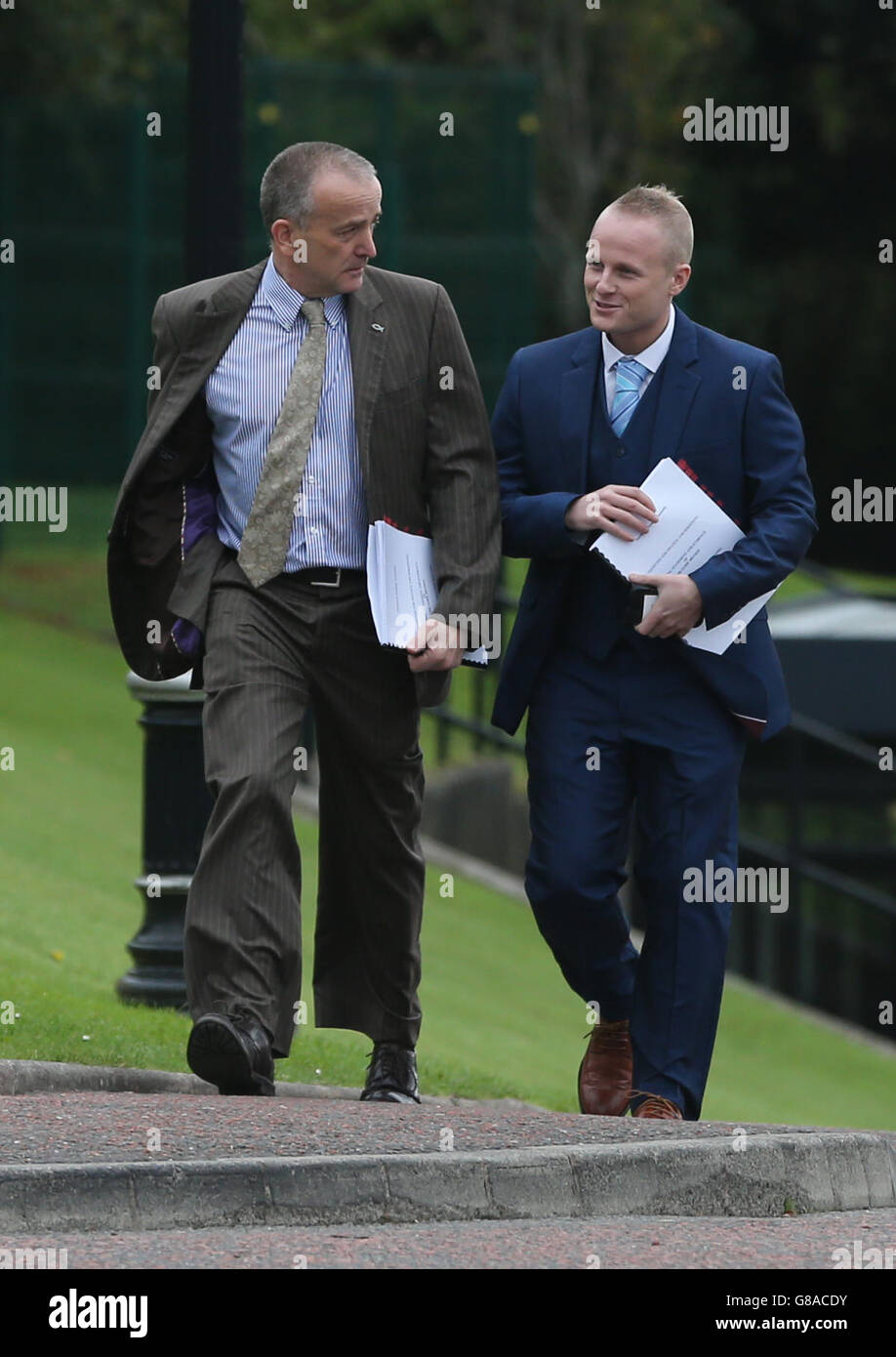 Jamie Bryson (right) arrives at Parliament Buildings in Belfast to give ...