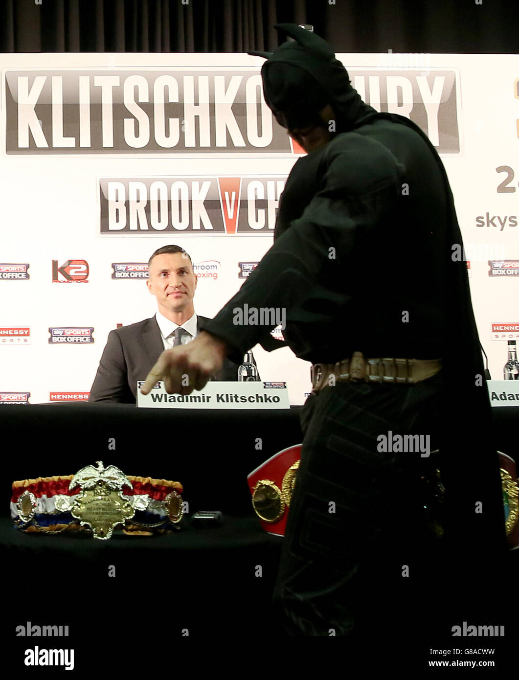 Tyson Fury dressed as batman shouts at Wladimir Klitschko as he points ...