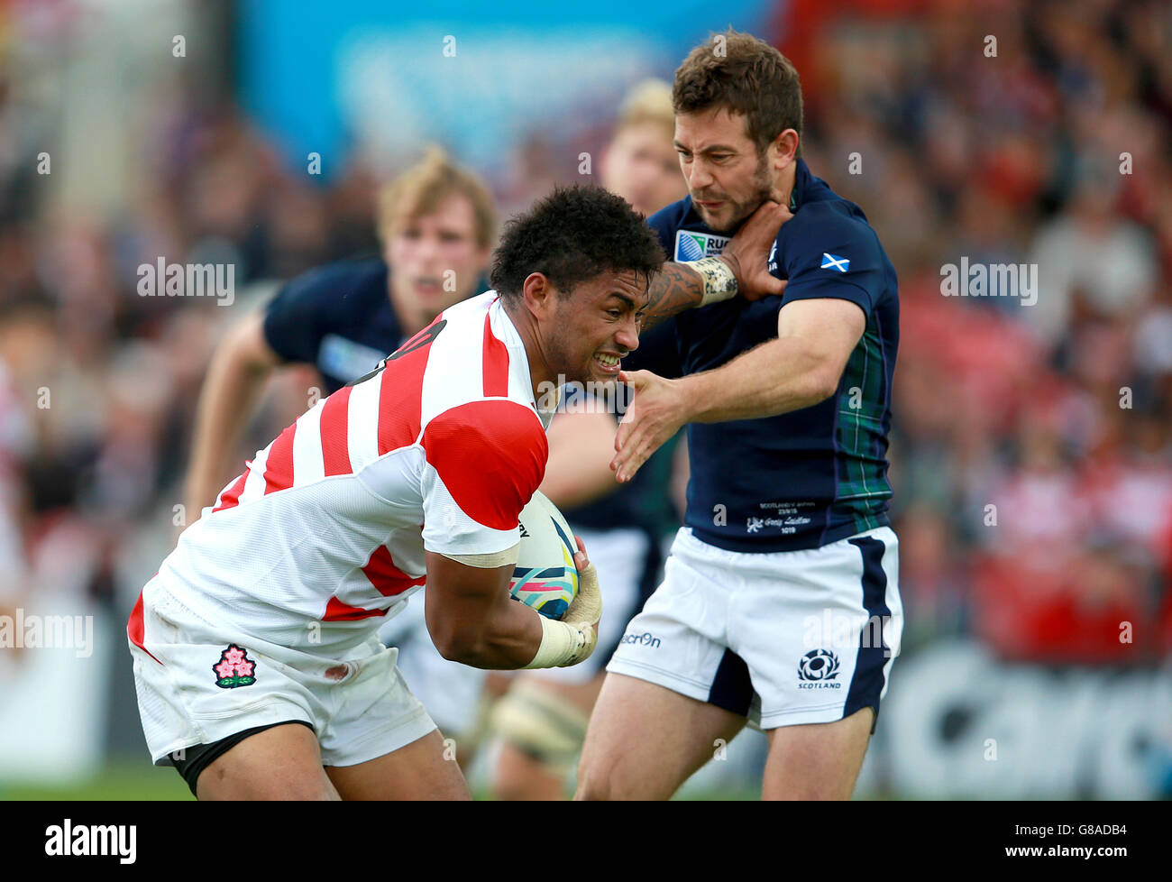 Japan's Amanaki Mafi (left) and Scotland's Greig Laidlaw in action ...