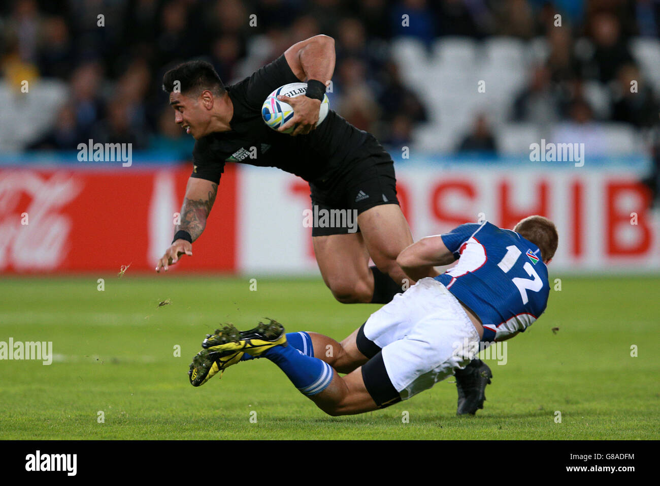New Zealand's Malakai Fekitoa (left) is halted by the tackle of Namibia ...