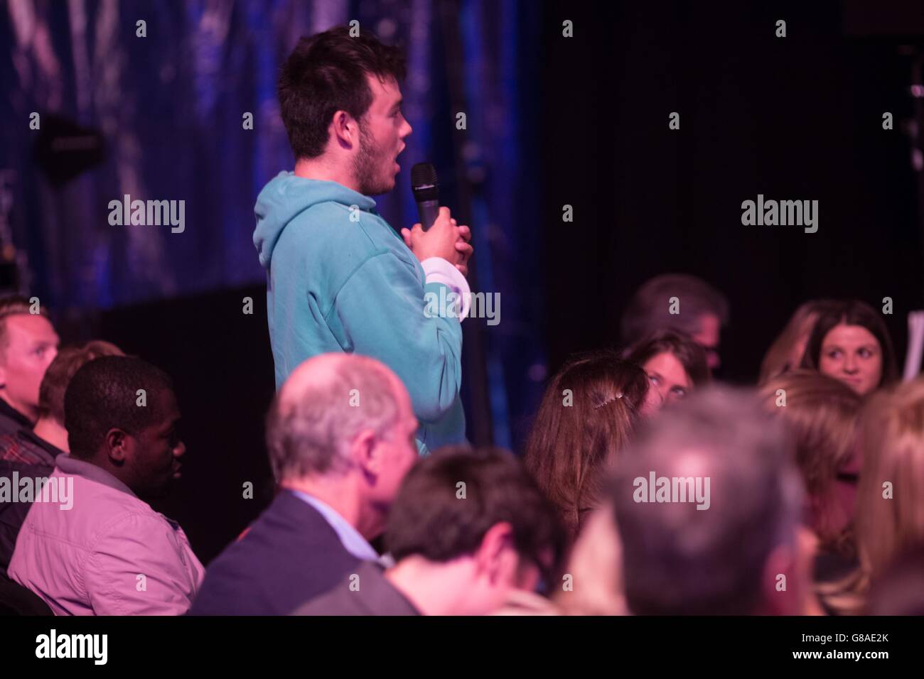 Audience members ask questions at the event hi-res stock photography ...