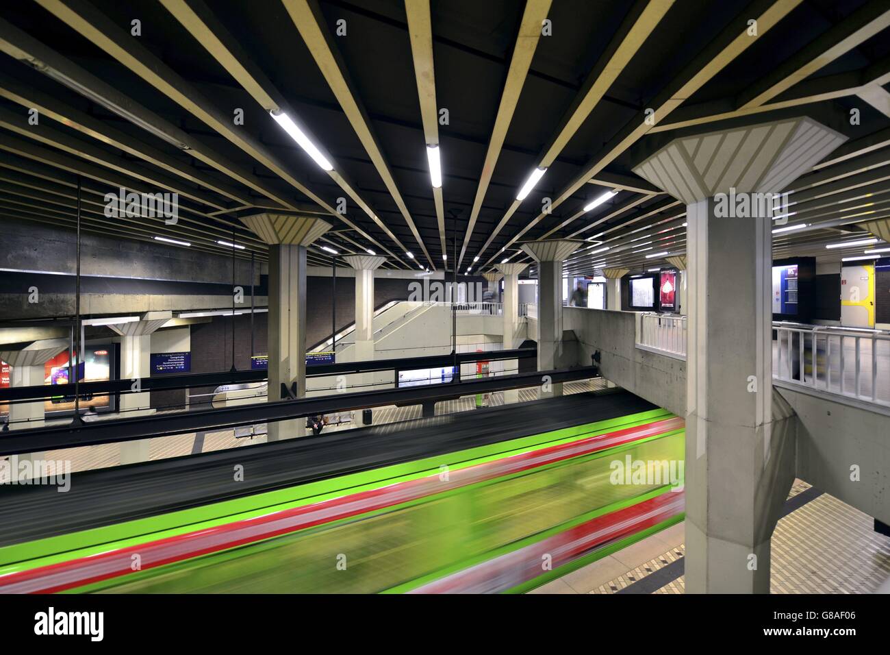 A green light rail vehicle in motion blur in the underground station ...
