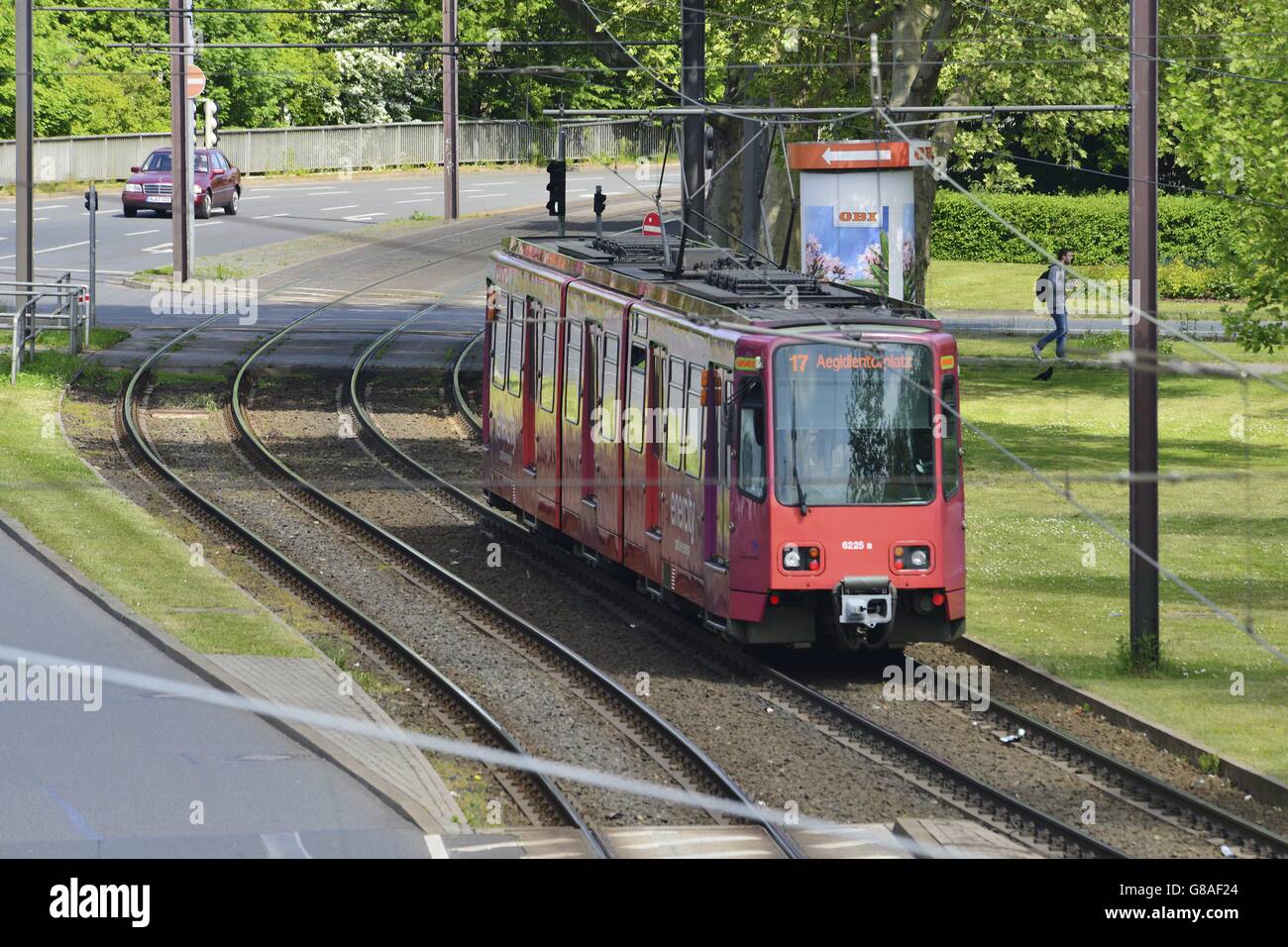 Red light rail vehicle from number 17 on the curved tracks on the ...