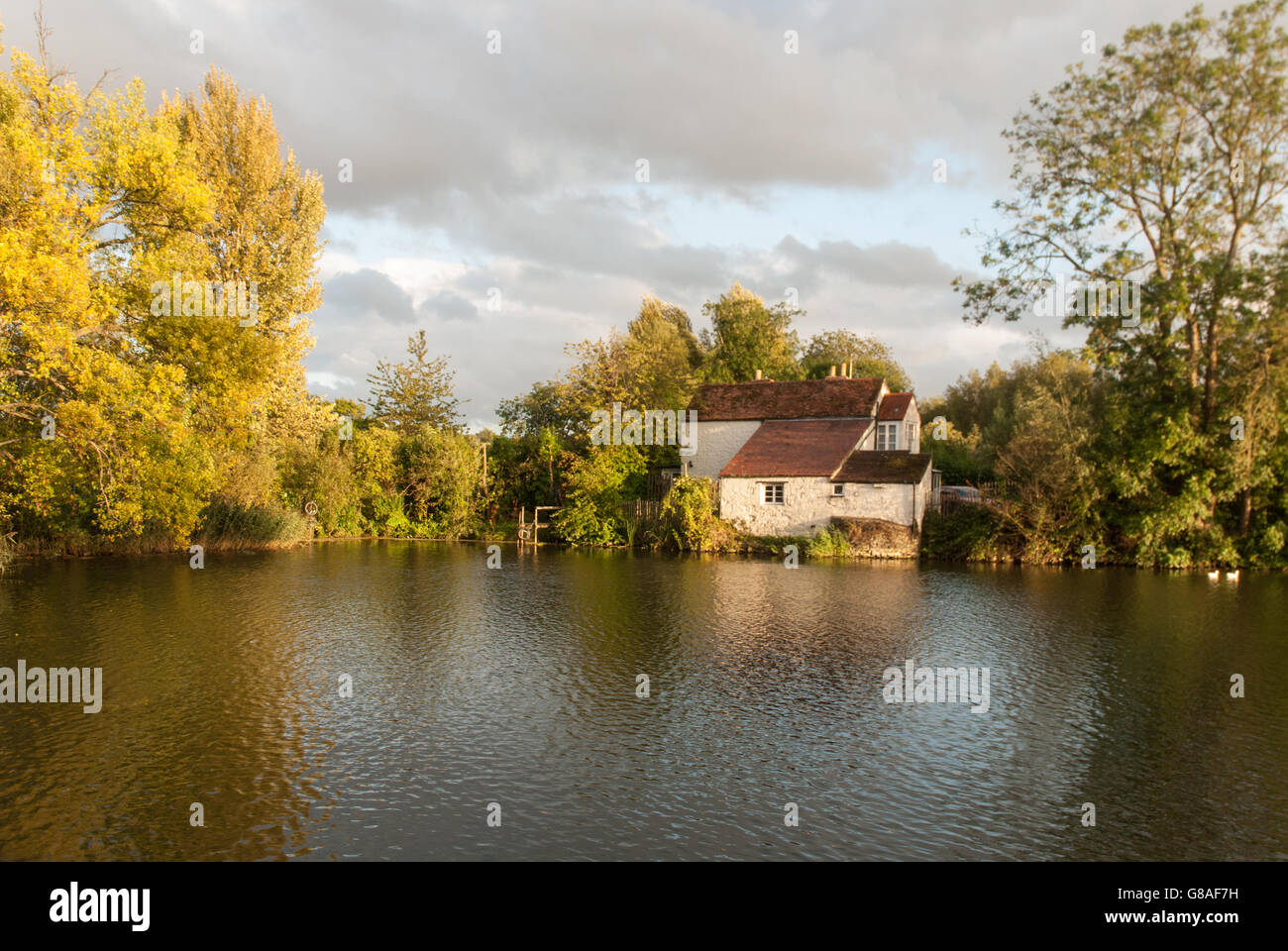 house at waterside in afternoon sunlight Stock Photo - Alamy