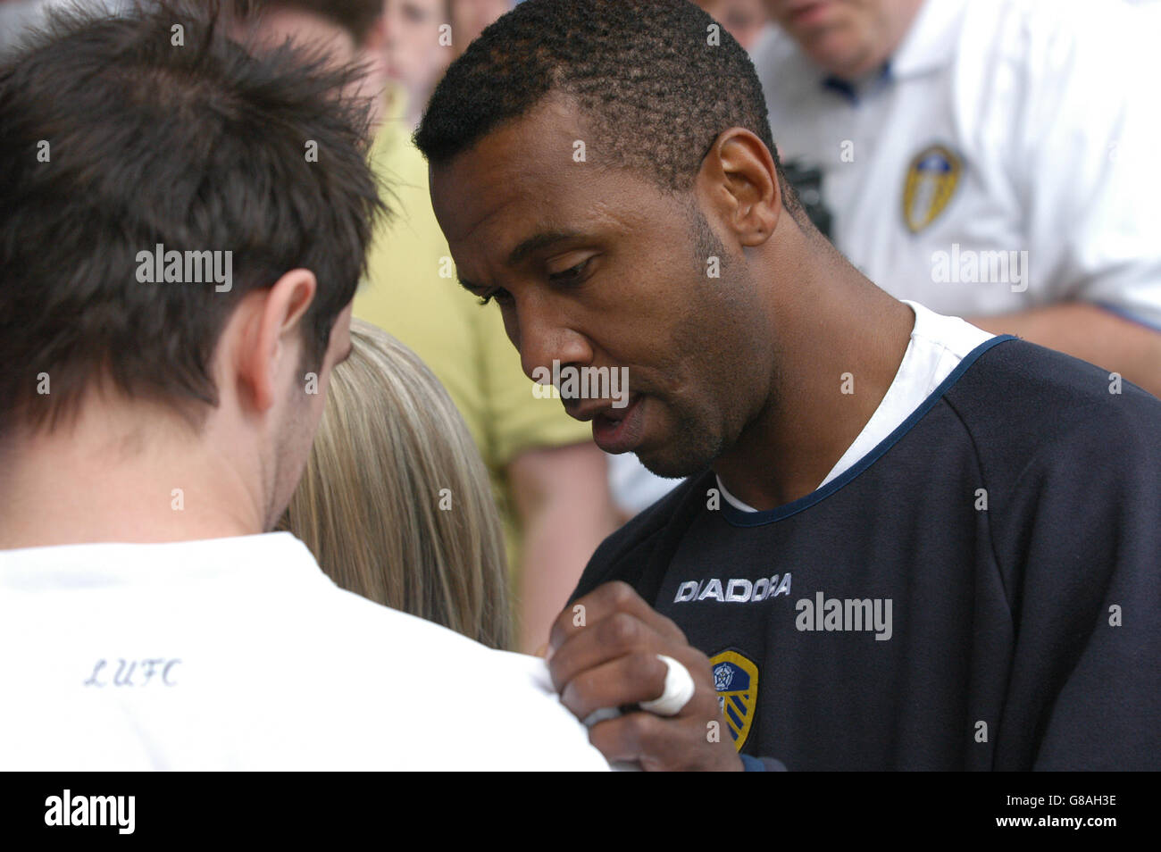 Lucas Radebe of Leeds United signs autographs for the fans ahead of his ...