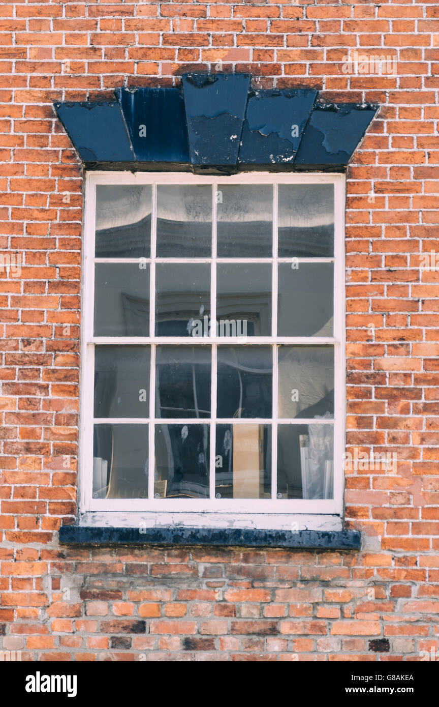 Old brick wall with a white window Stock Photo - Alamy