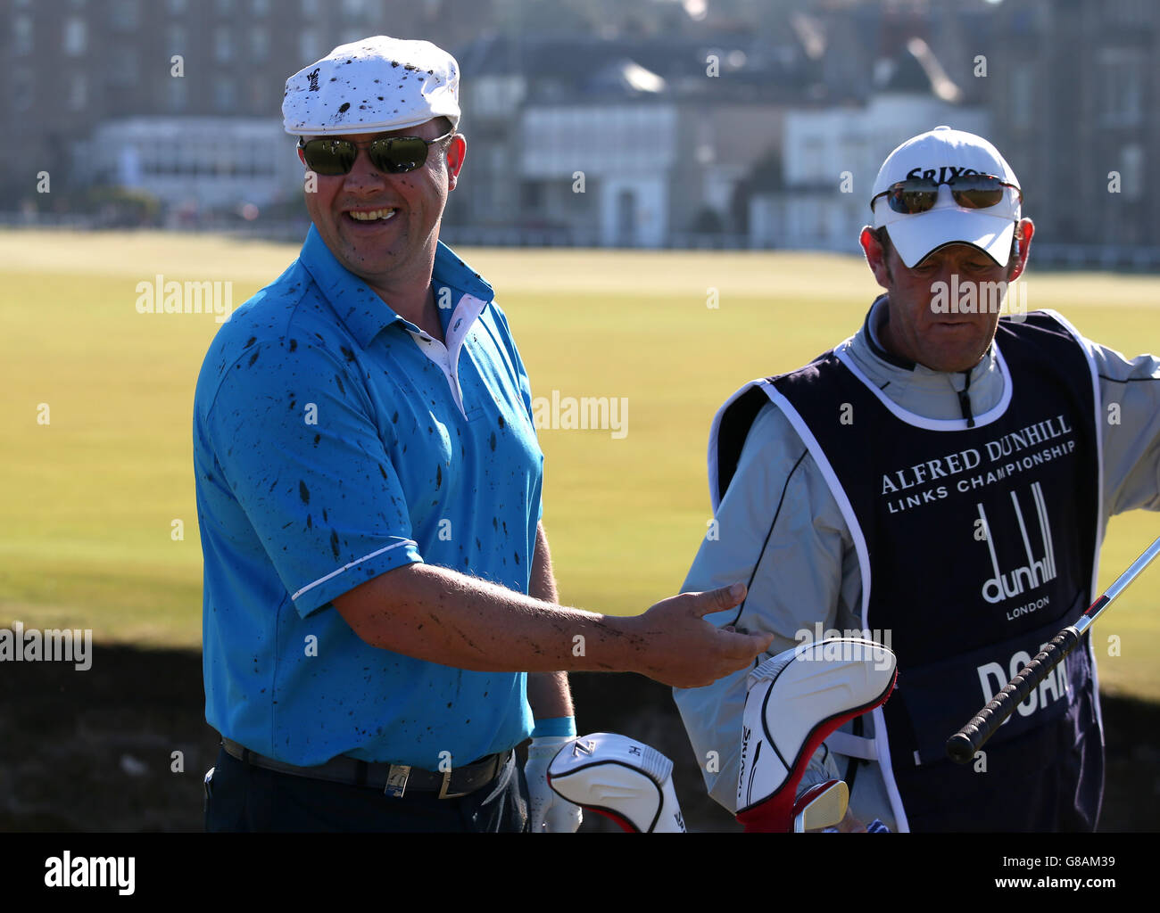 Scotland's Chris Doak cleans up after playing a shot out of the Swilken ...