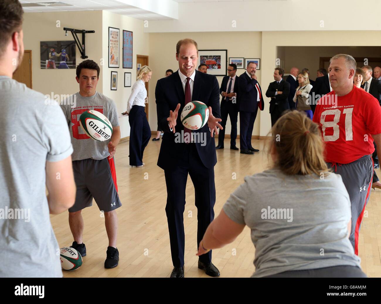 The Duke of Cambridge catches a rugby ball during a visit to the ...