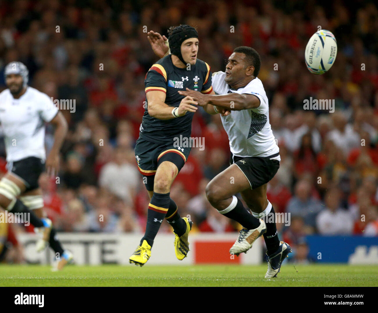 Wales' Matthew Morgan is tackled by Fiji's Timoci Nagusa (right) during ...