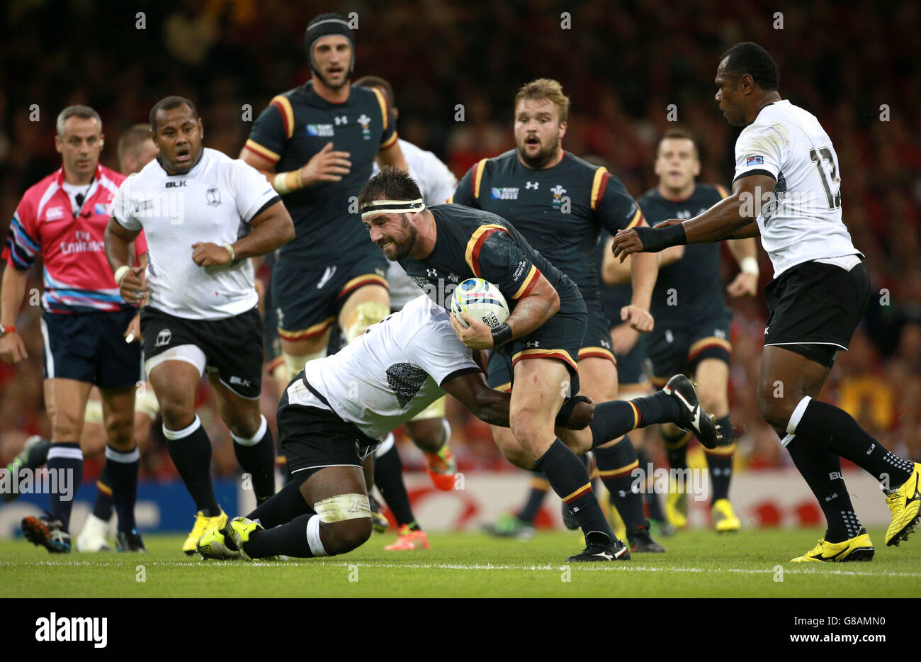 Wales' Scott Baldwin is tackled by Fiji's Manasa Saulo (left) and Niki ...