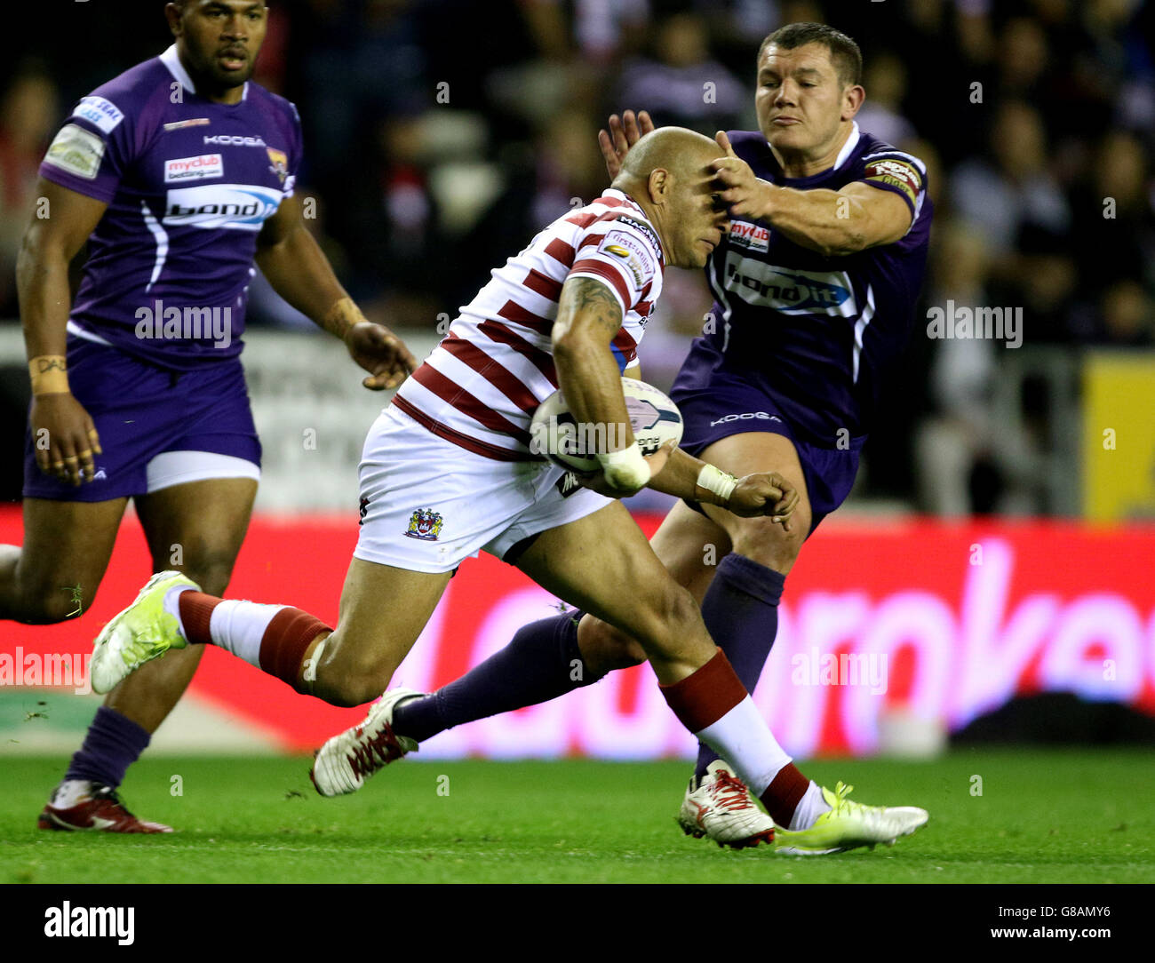 Wigan Warriors' Matty Bowen charges past Huddersfield Giants' Brett ...