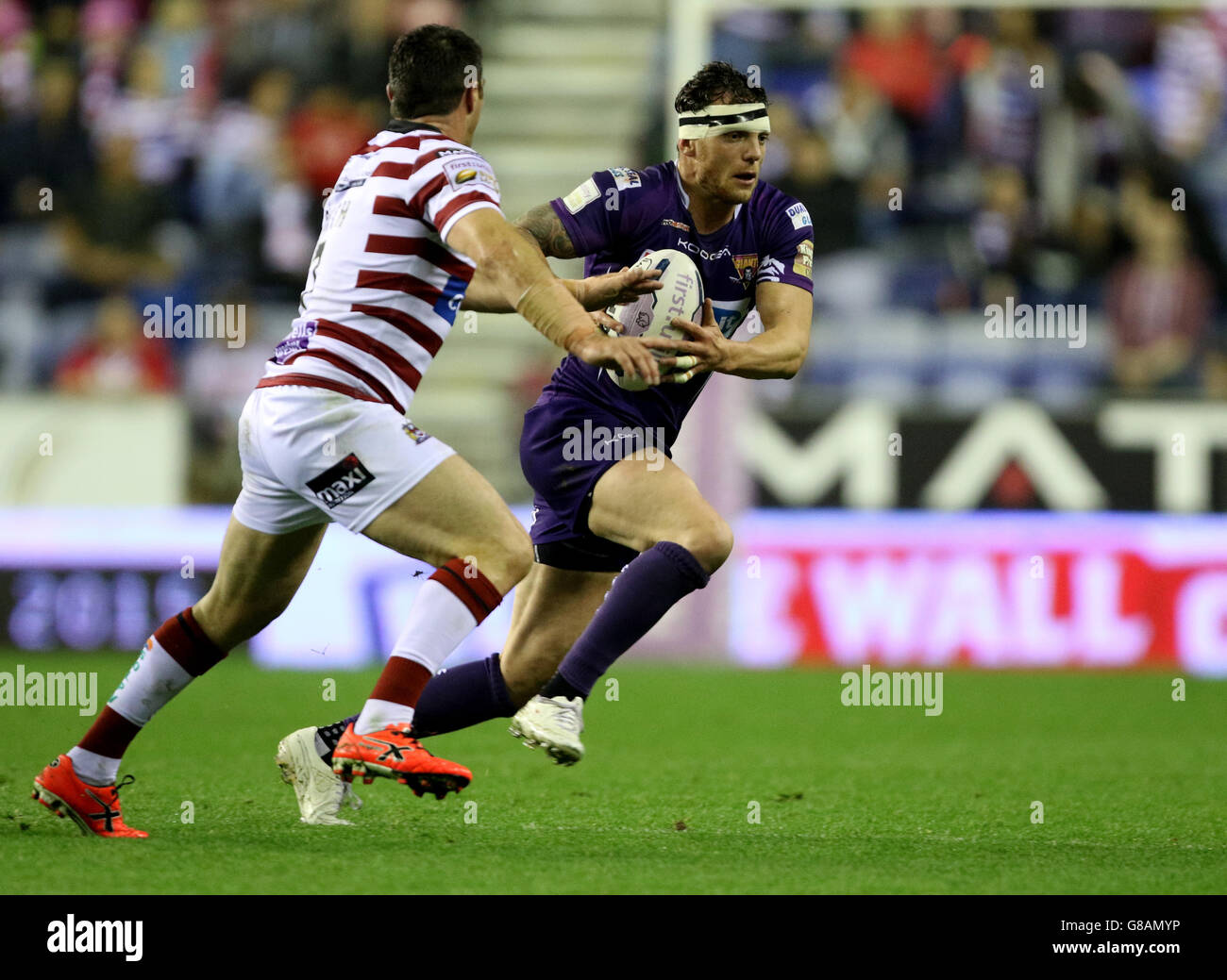 Huddersfield Giants Scott Grix (right) looks to break away from Wigan ...