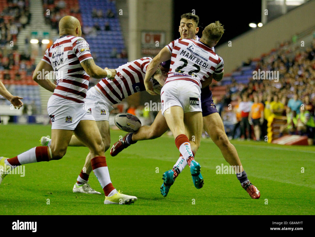 Huddersfield Giants' Aaron Murphy is tackled by Wigan Warriors' Dominic ...