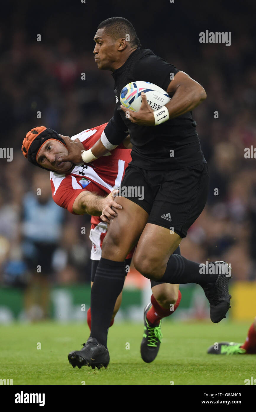 New Zealand's Waisake Naholo (right) hands off Georgia's Beka Tsiklauri ...