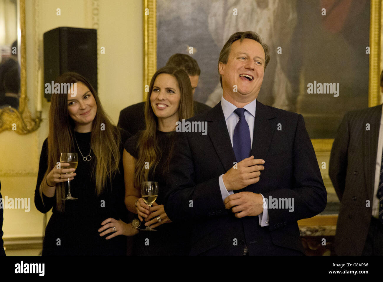 Prime Minister David Cameron laughs as he listens to a speech during a ...