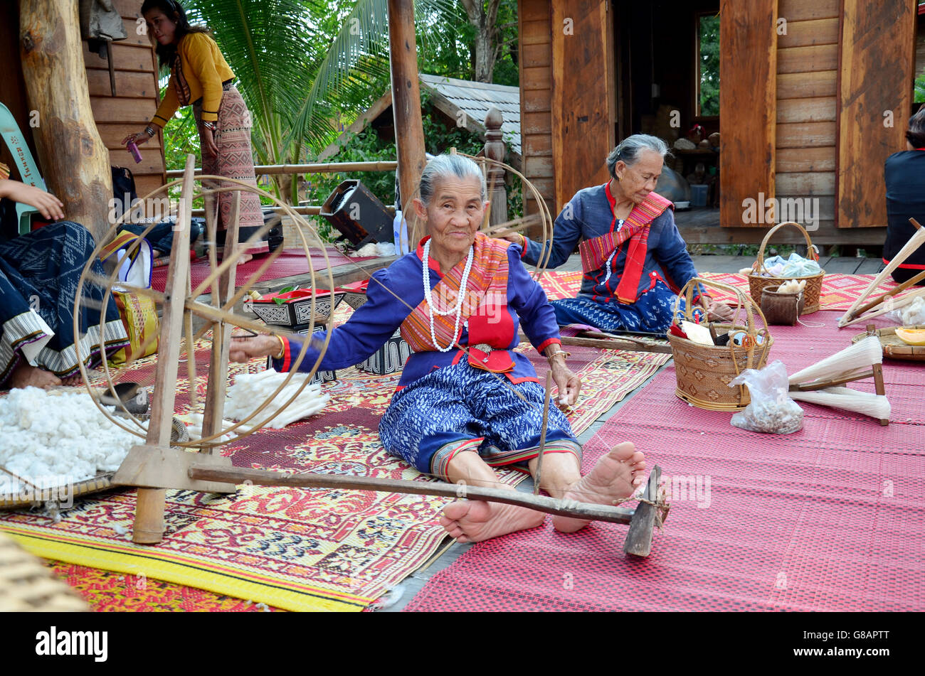 Phu Thai people using spinning cotton thread machine for show traveller ...