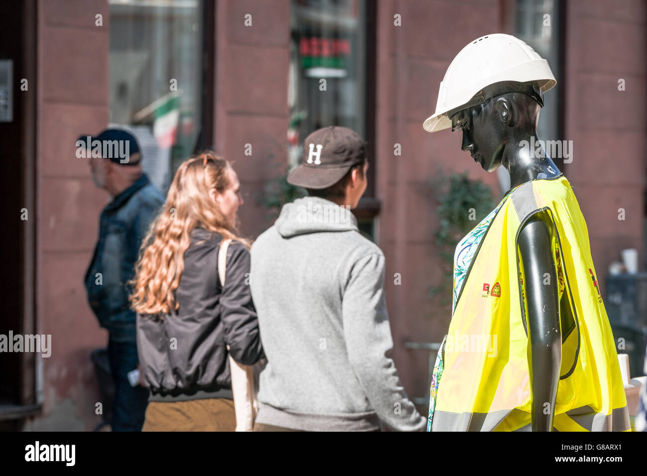 Black fashion dummies standing in the street, one dummy with safety ...