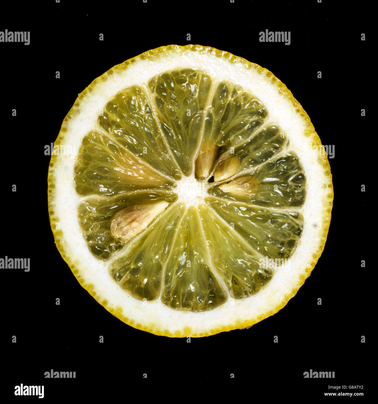 Slice of lemon on black background Stock Photo - Alamy
