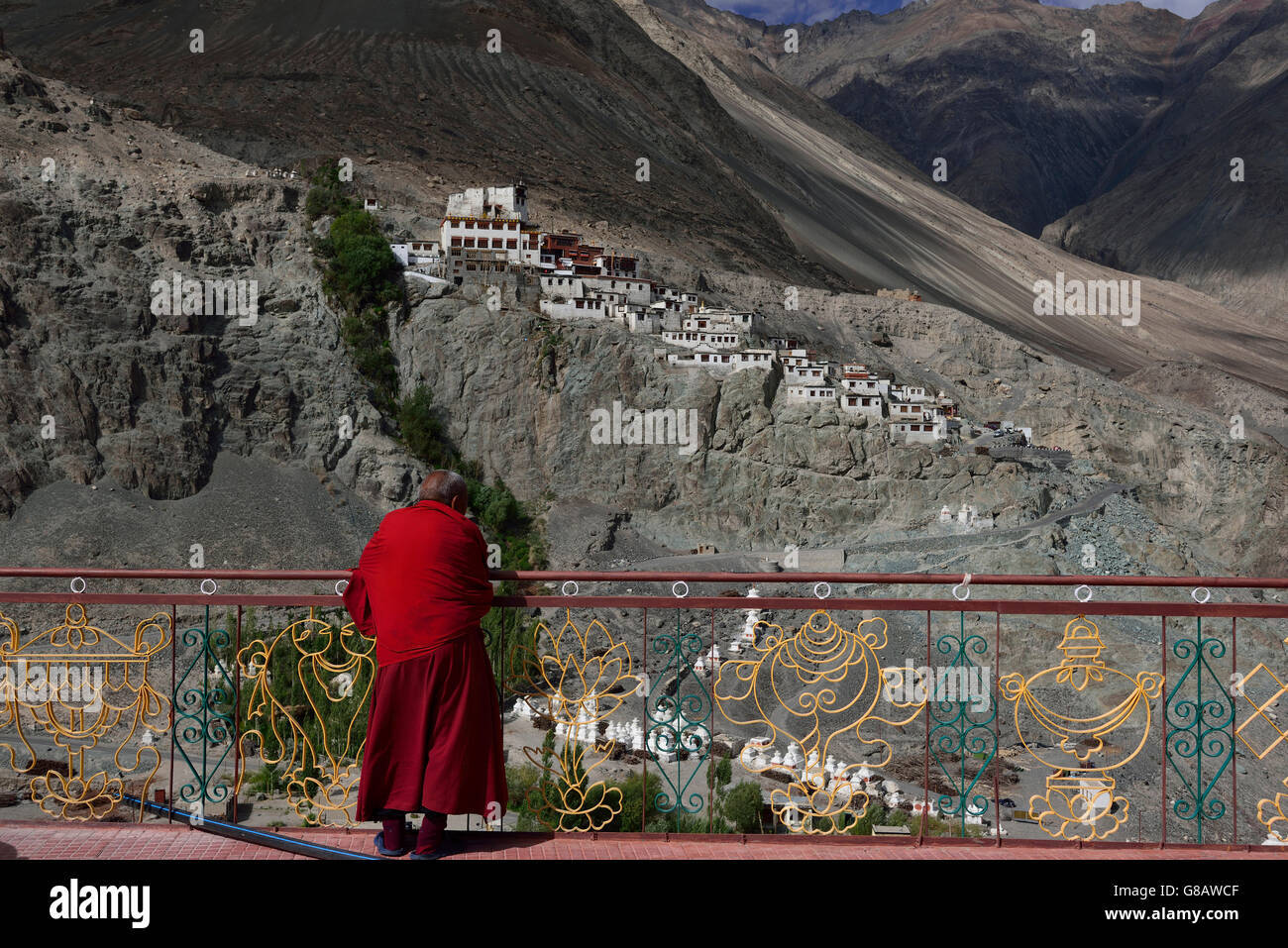 monk with Diskit Monastery in the background, Nubra-Valley, Ladakh ...