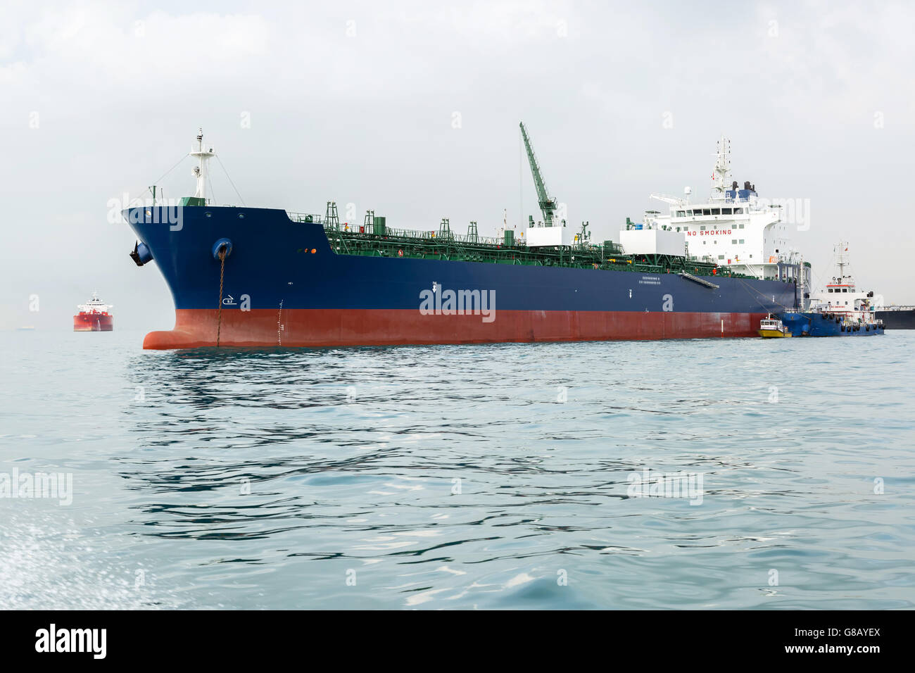 Blue and red ship in the sea while calm weather during bunkering ...