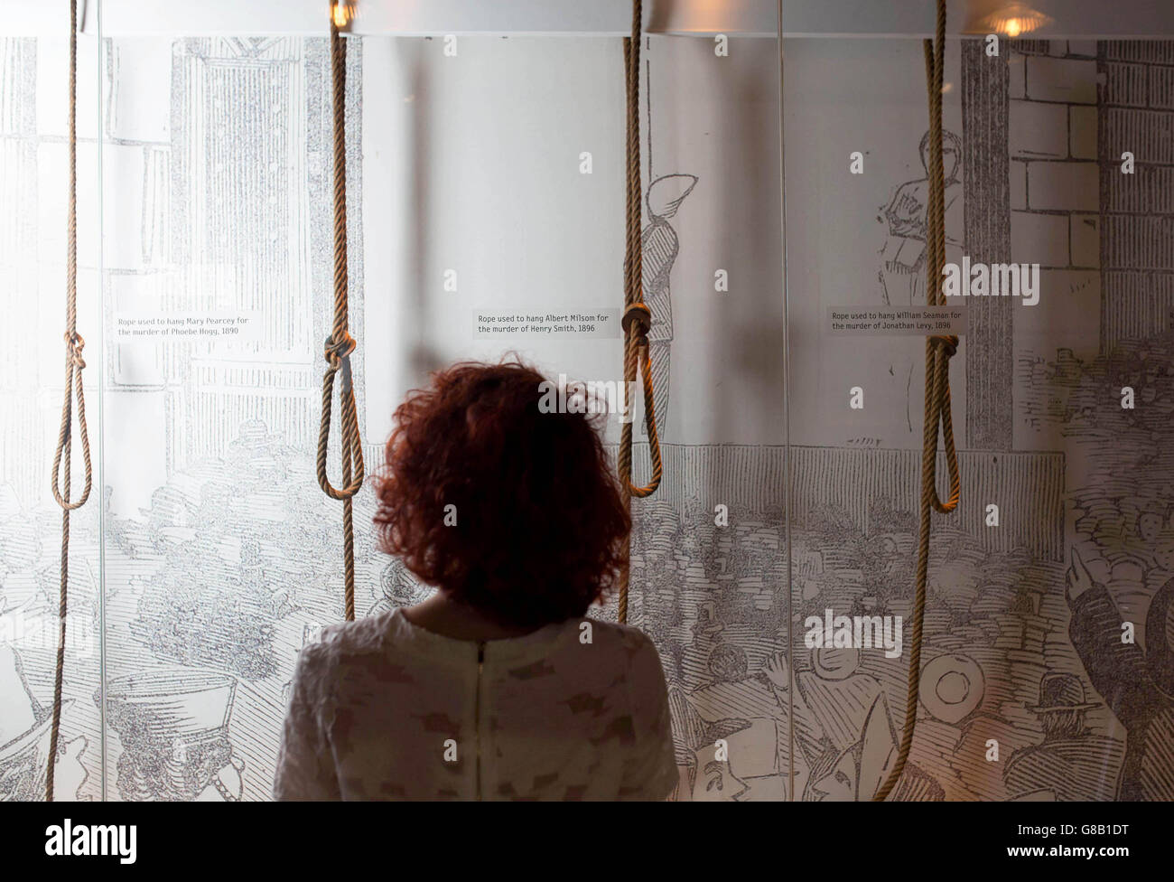 Museum employee Sian-Estelle Petty looks at execution ropes from the ...
