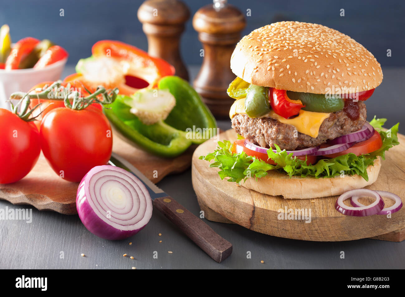 homemade cheese burger with peppers tomato onion Stock Photo - Alamy