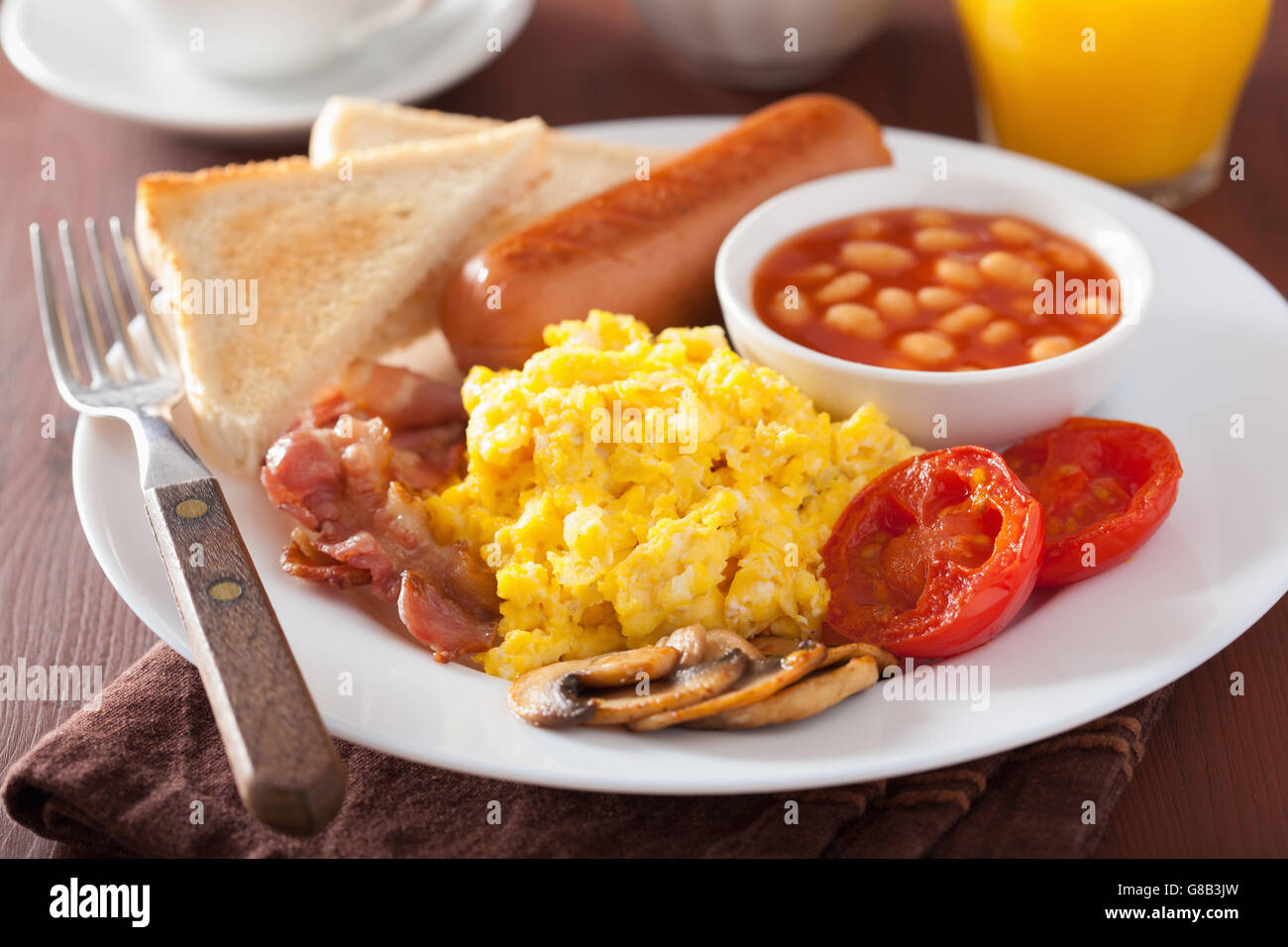 full english breakfast with scrambled eggs, bacon, sausage, beans ...