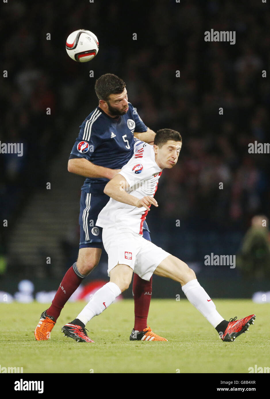 Scotland's Grant Hanley (left) and Poland's Robert Lewandowski battle ...