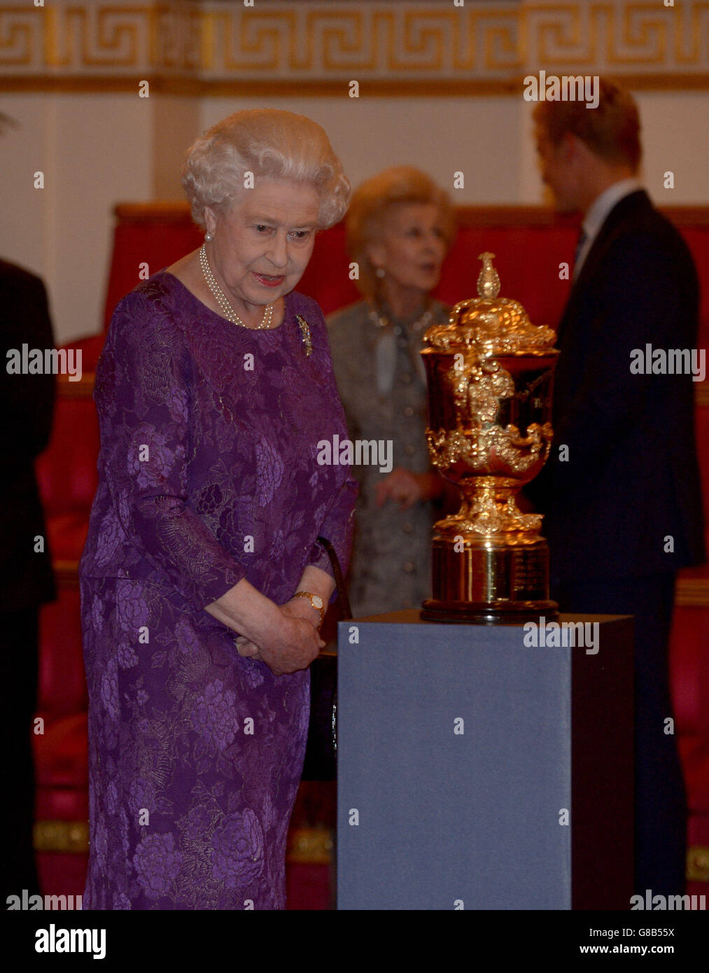 Queen Elizabeth II looks at the Webb Ellis Cup on a plinth at a ...