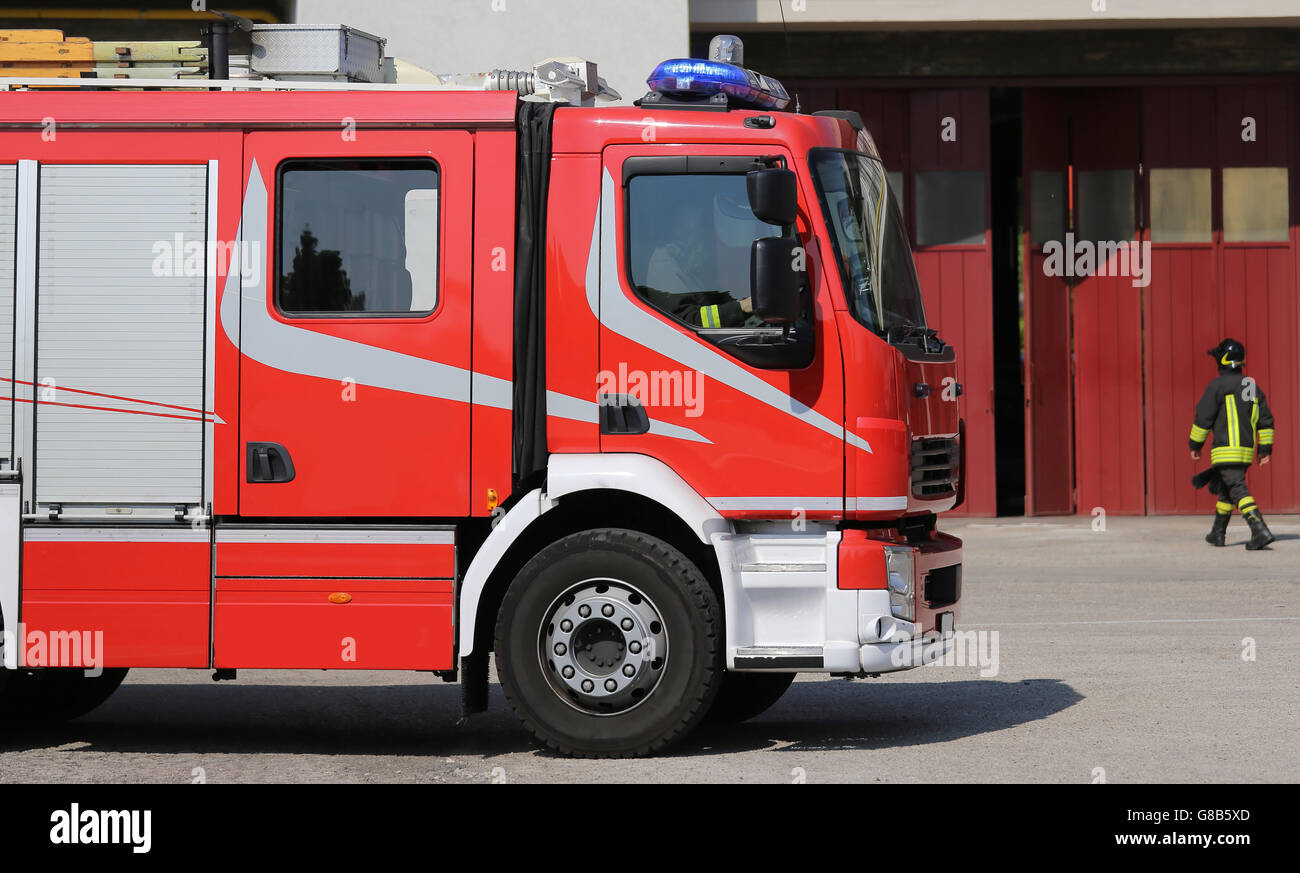 red fire engine truck during a fire drill in the fire brigade station ...