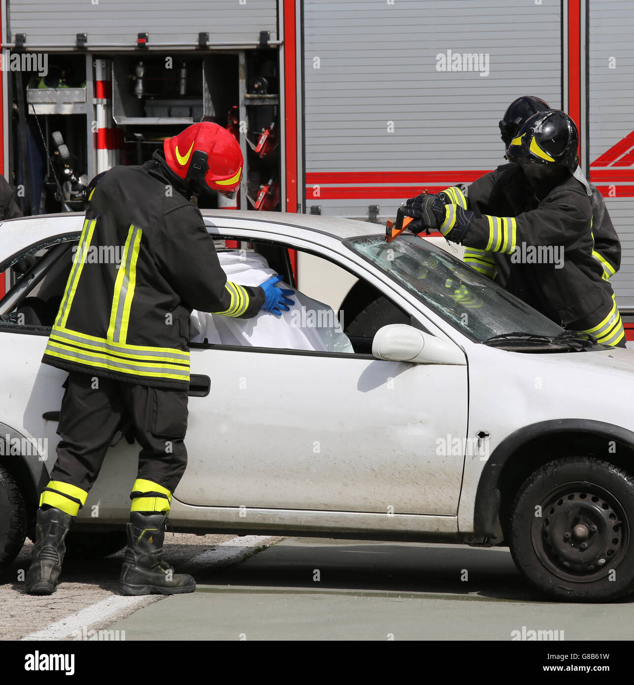 firefighters in action after the road accident Stock Photo - Alamy