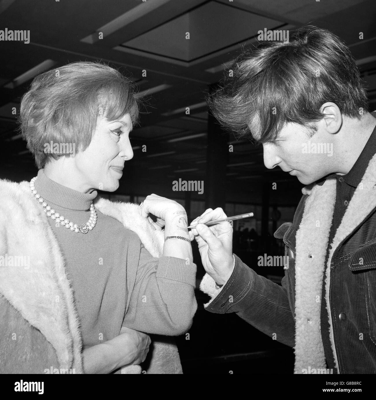 Actor David Buck uses a Biro to drawn on the wrist of actress Maxine ...