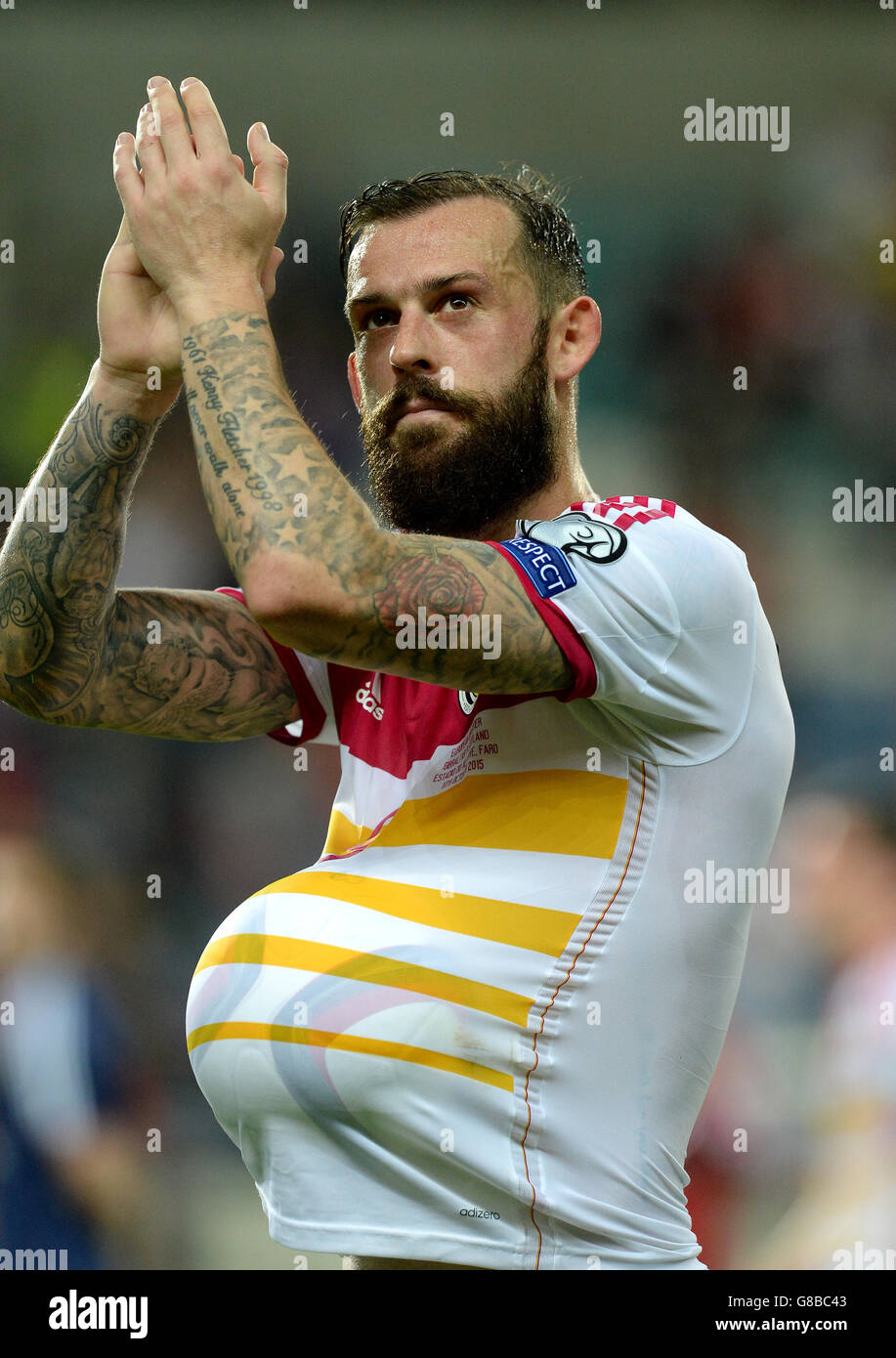 Scotland's Steven Fletcher leaves the pitch with the match ball after ...