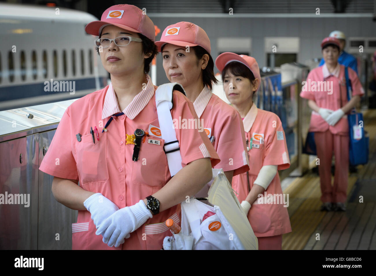 Cleaners wait to board a 'bullet train' at Tokyo Station in Japan ...