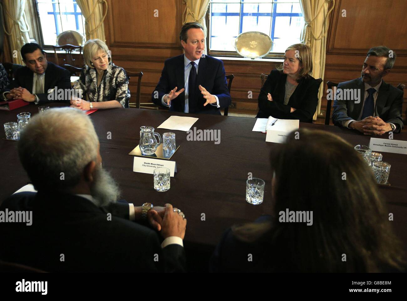 Prime Minister David Cameron (centre), alongside Lord Ahmad (left ...